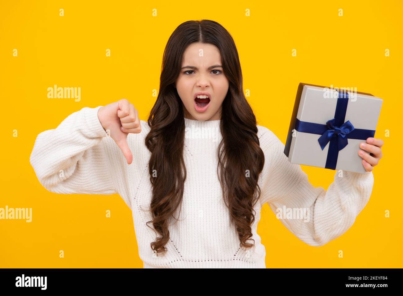Angry face, upset emotions of teenager girl. Child teen girl with gift ...