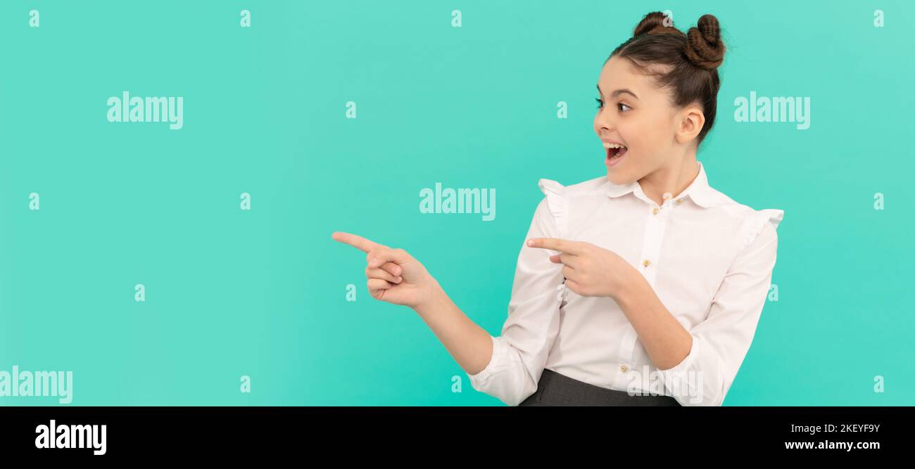 Exclusive. Happy schoolchild point fingers. Pointing gesture. Pointing ...