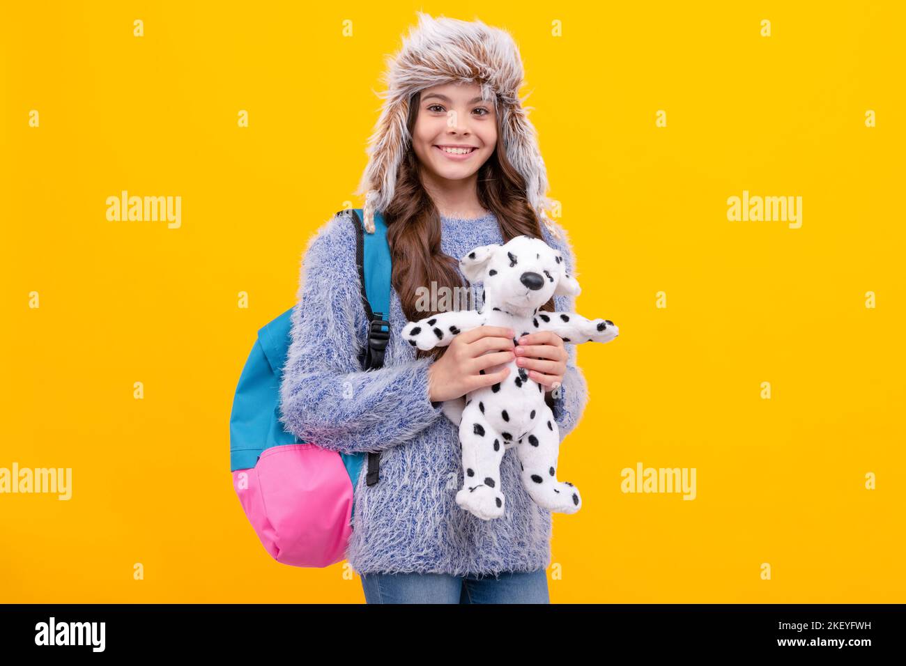 child wearing warm clothes carry backpack. express positive emotion ...