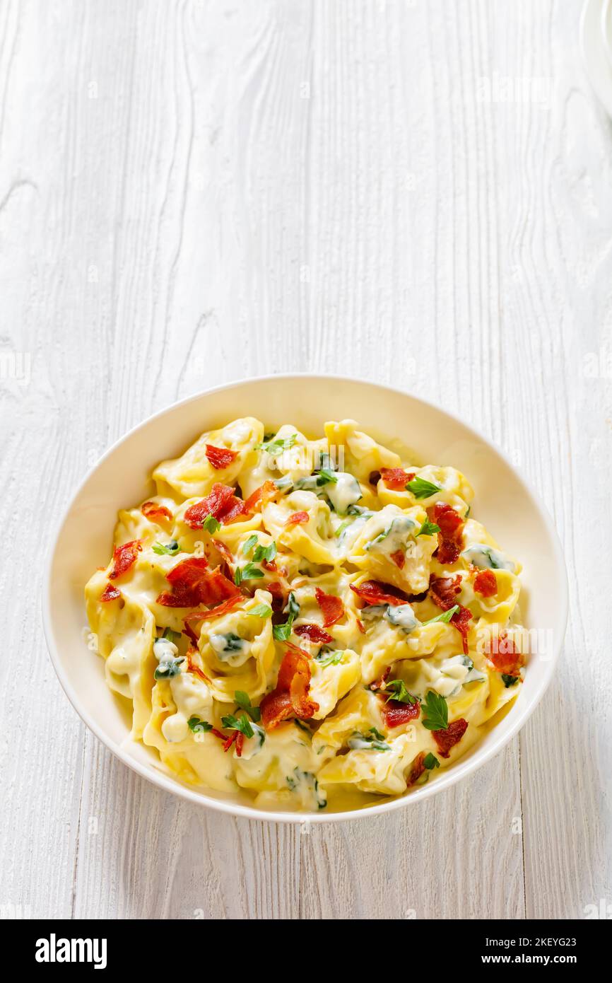 tortellini in creamy cheese sauce with crispy bacon and parsley in ...