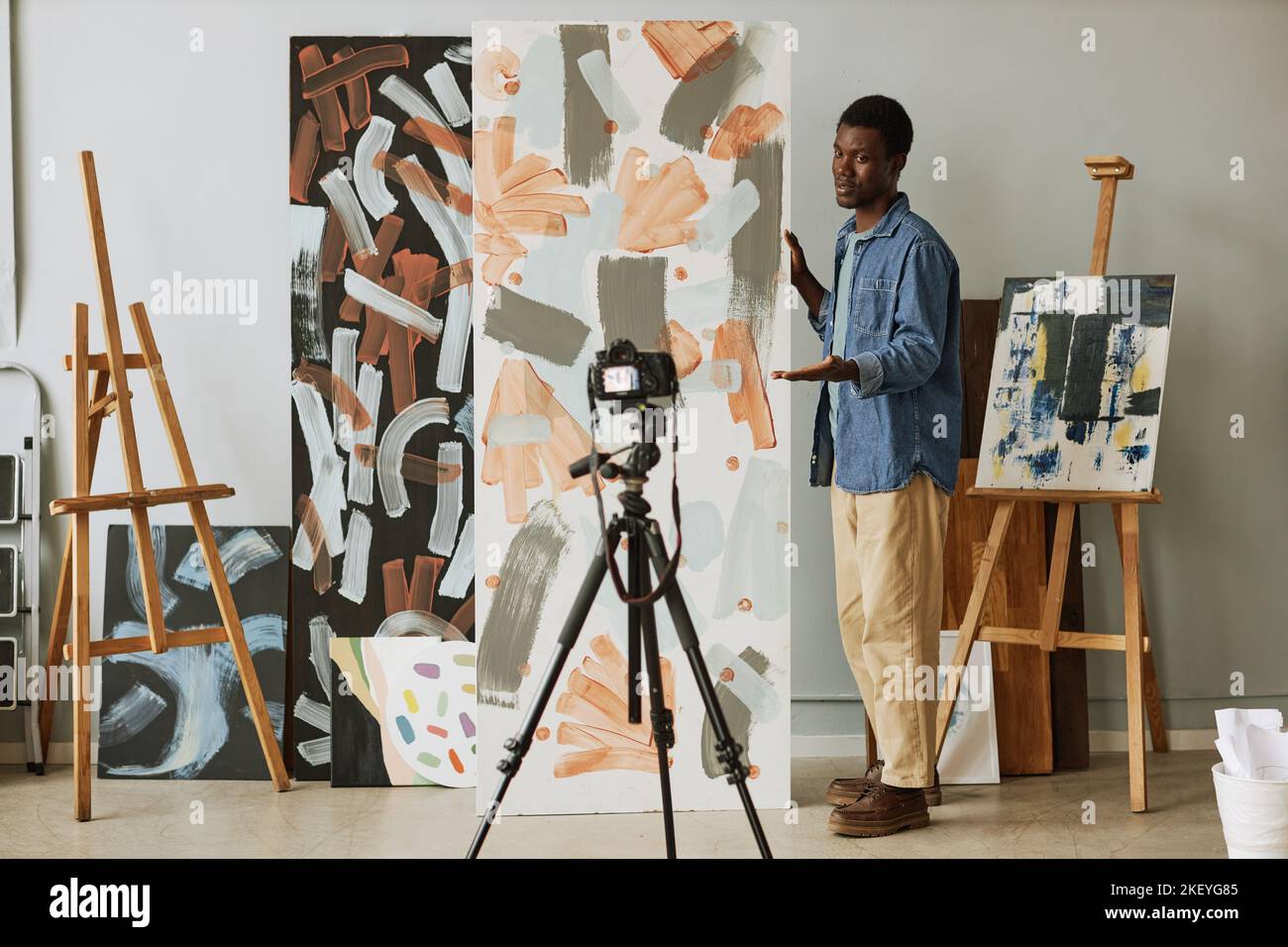Young confident African American painter making presentation of his ...