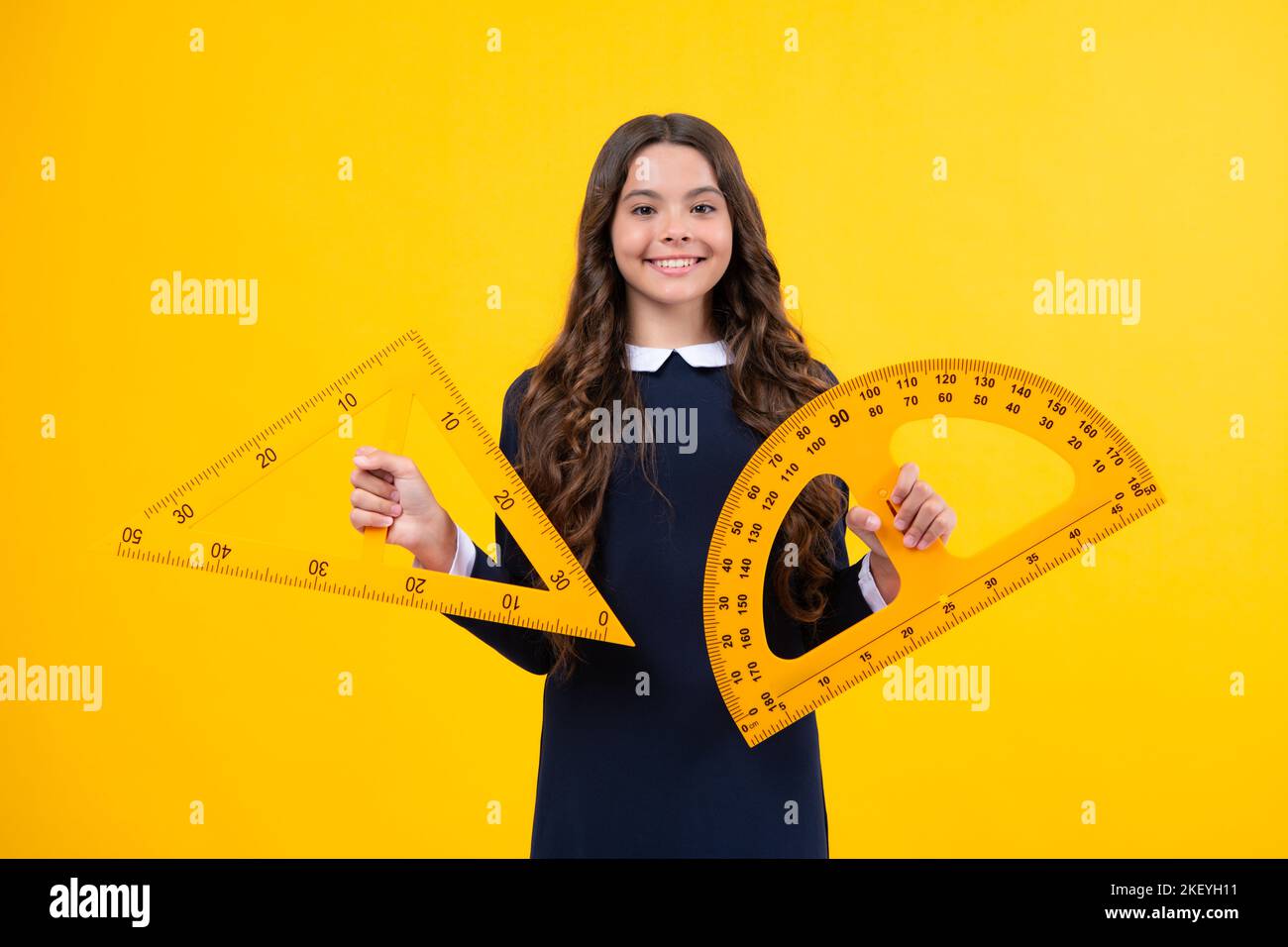 Teenager school girl study math or geometry lesson, measure the size ...