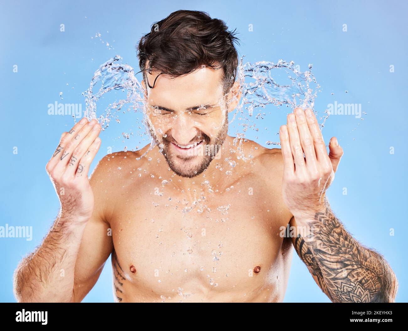 Grooming, splash and man washing face with water for cleaning, hygiene and wellness against a ...