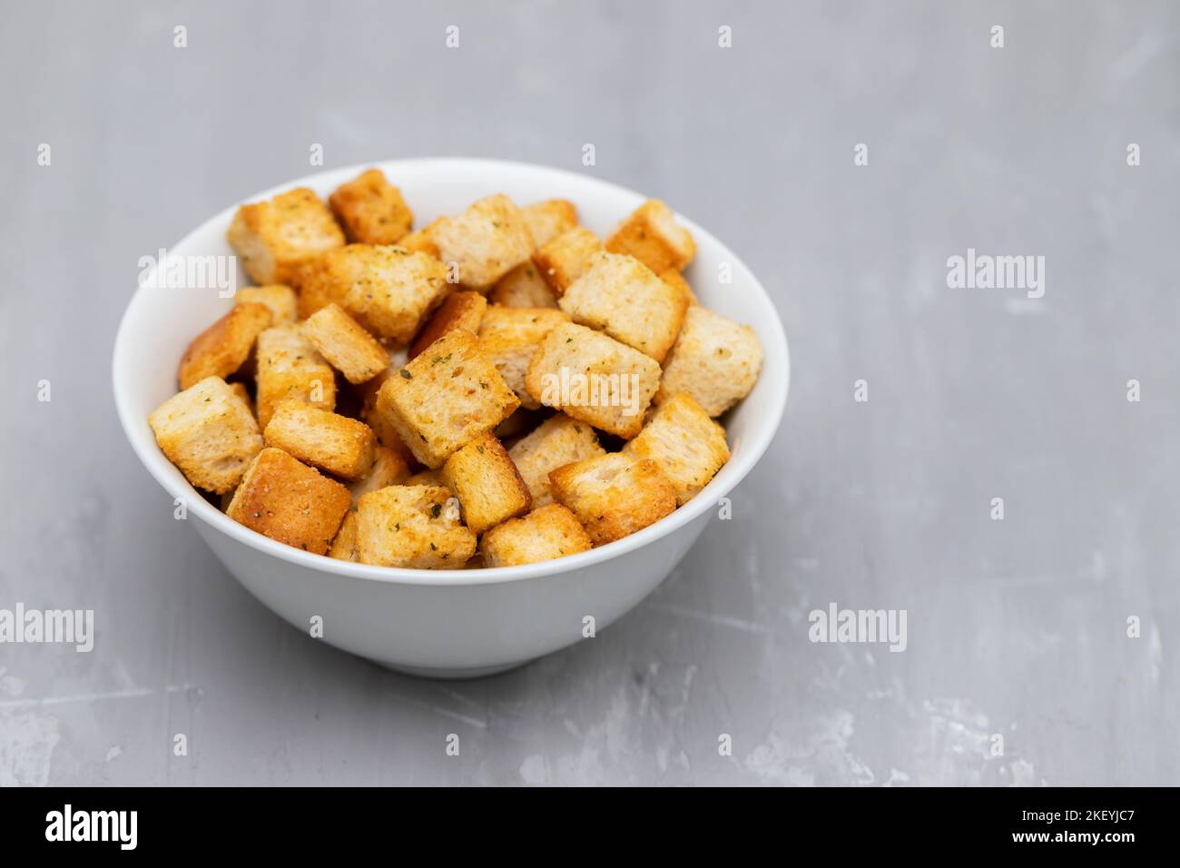 Crispy dry cubes of white bread in white bowl Stock Photo - Alamy