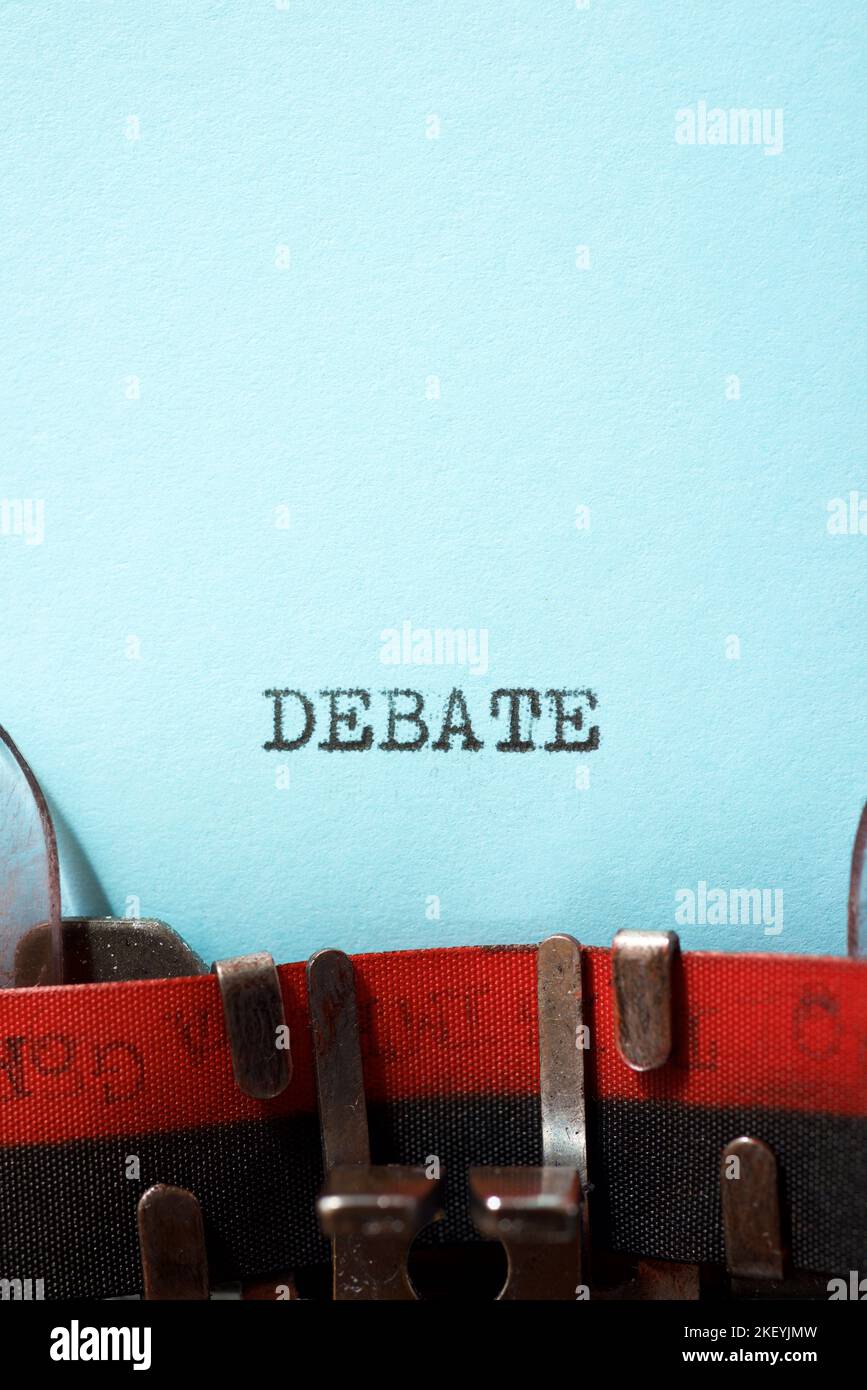 Debate word written with a typewriter Stock Photo - Alamy