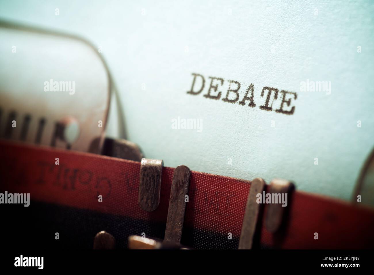 Debate word written with a typewriter Stock Photo - Alamy