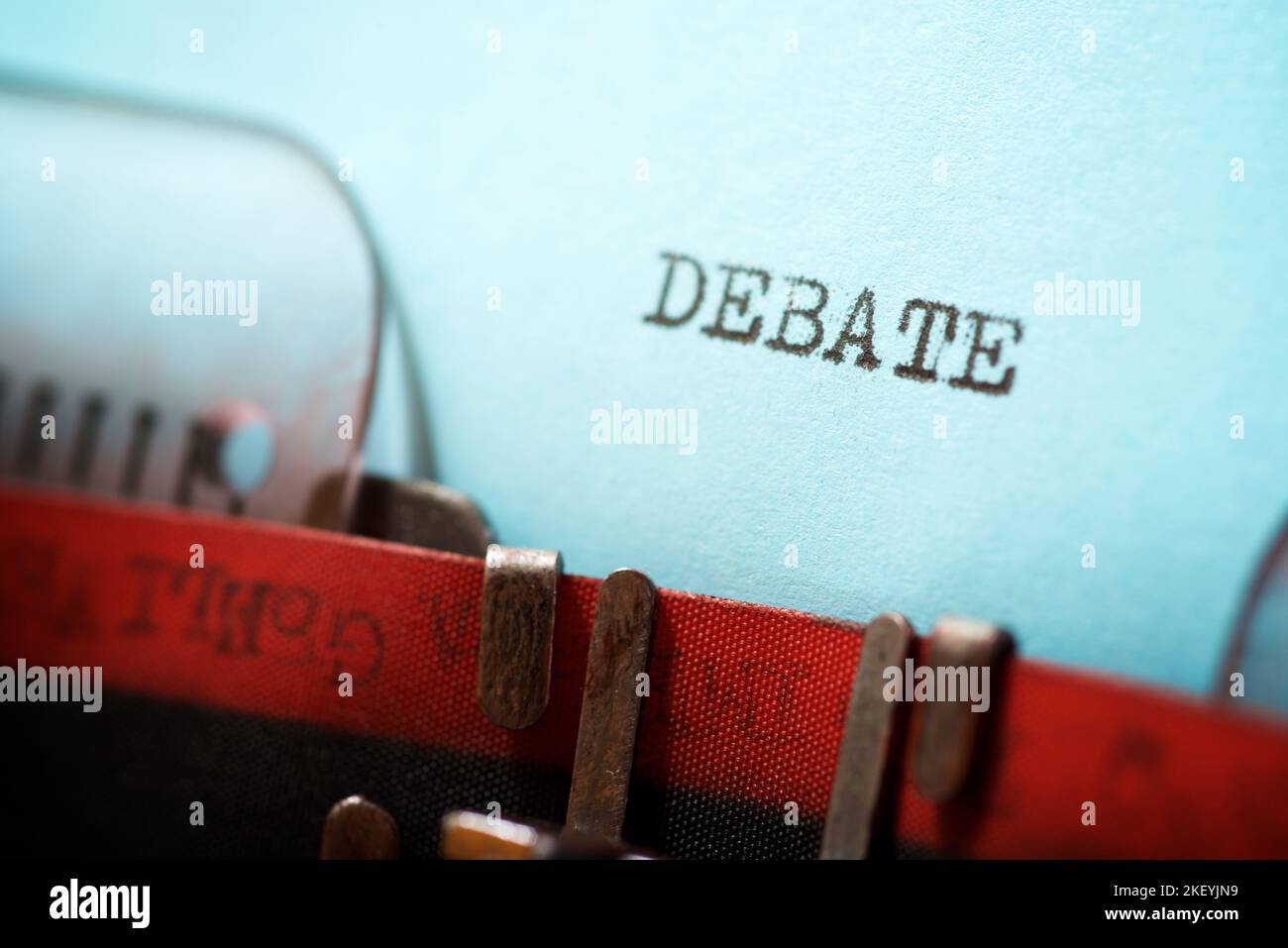 Debate word written with a typewriter Stock Photo - Alamy