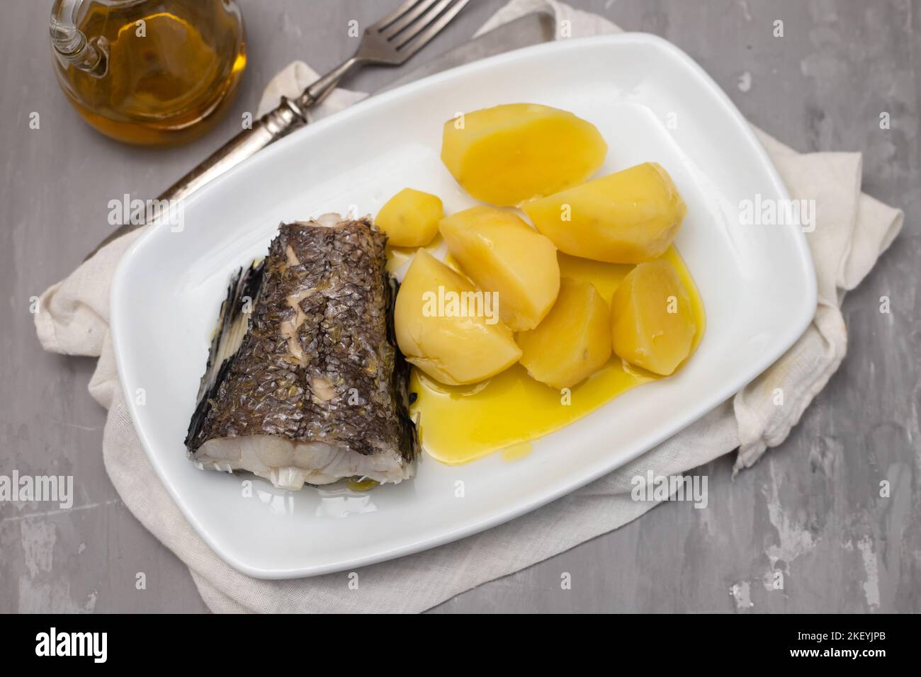 baked vegetables with boiled fish on white plate on blue Stock Photo ...