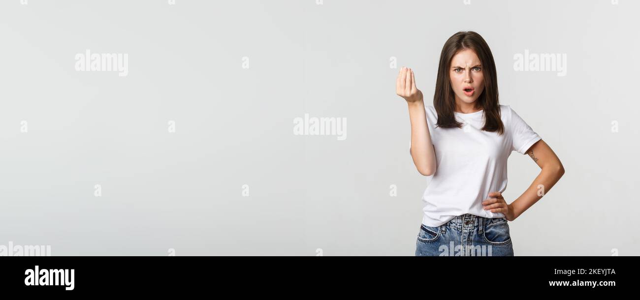 Confused and angry brunette girl arguing about money Stock Photo - Alamy