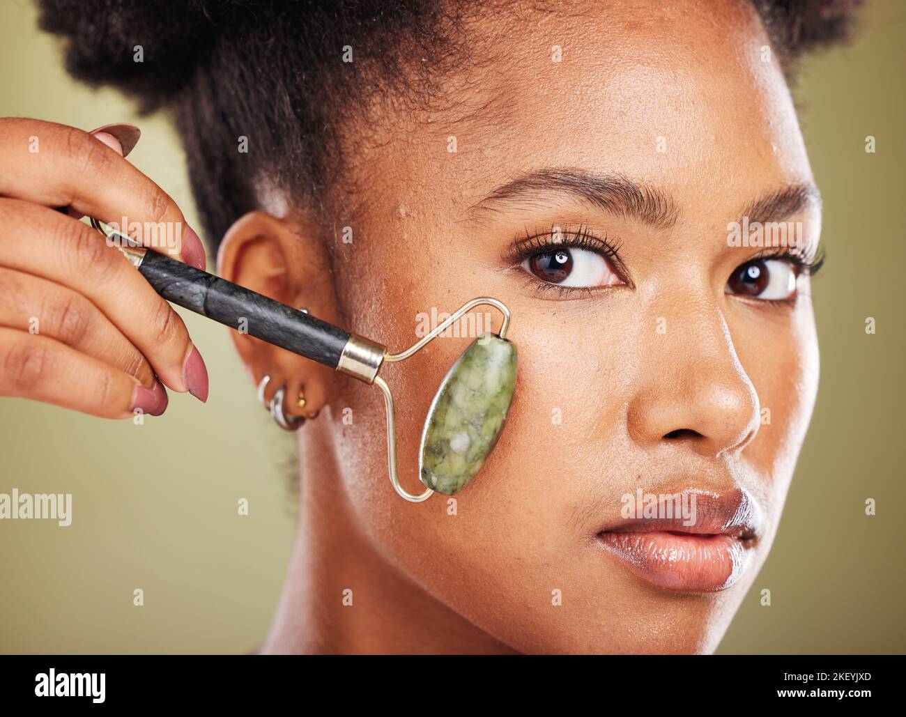 Face roller, skincare and black woman with crystal face massage for ...