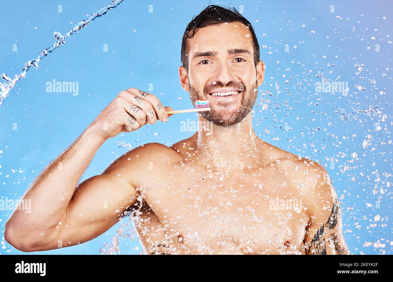 Man, toothbrush and smile for dental care, hygiene and cosmetics against an aqua blue studio ...