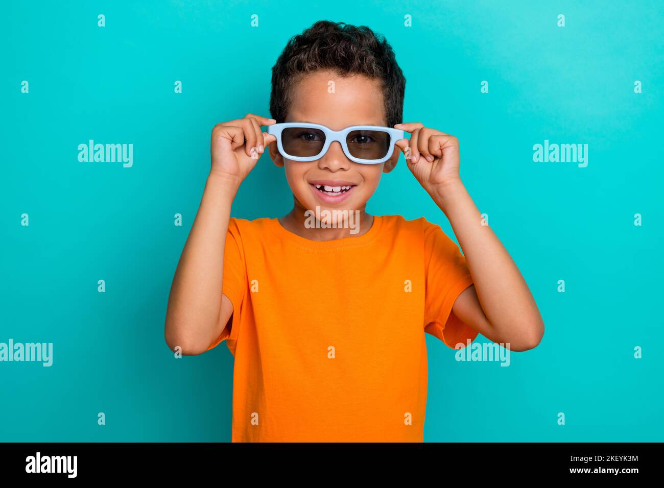 Photo of funny pretty little guy dressed orange t-shirt arms dark ...