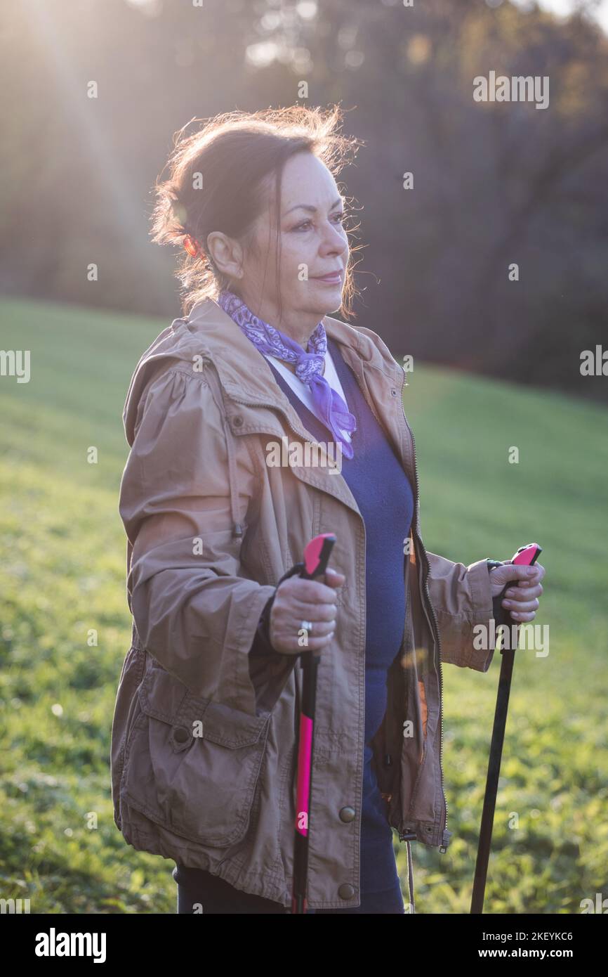 Portrait of an elder lady nordic walking in the countryside Stock Photo ...