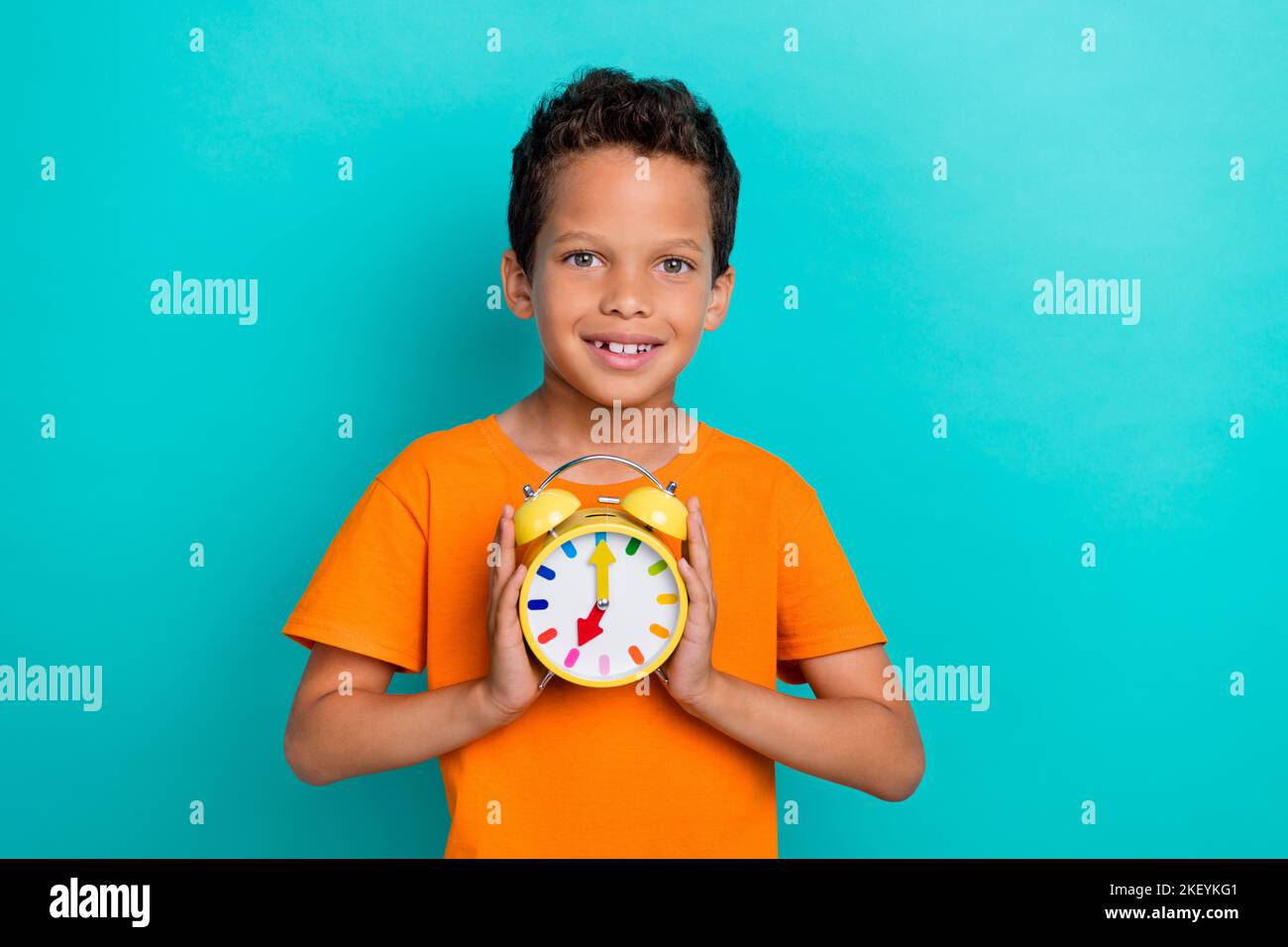 Photo of charming adorable little guy dressed orange t-shirt holding ...