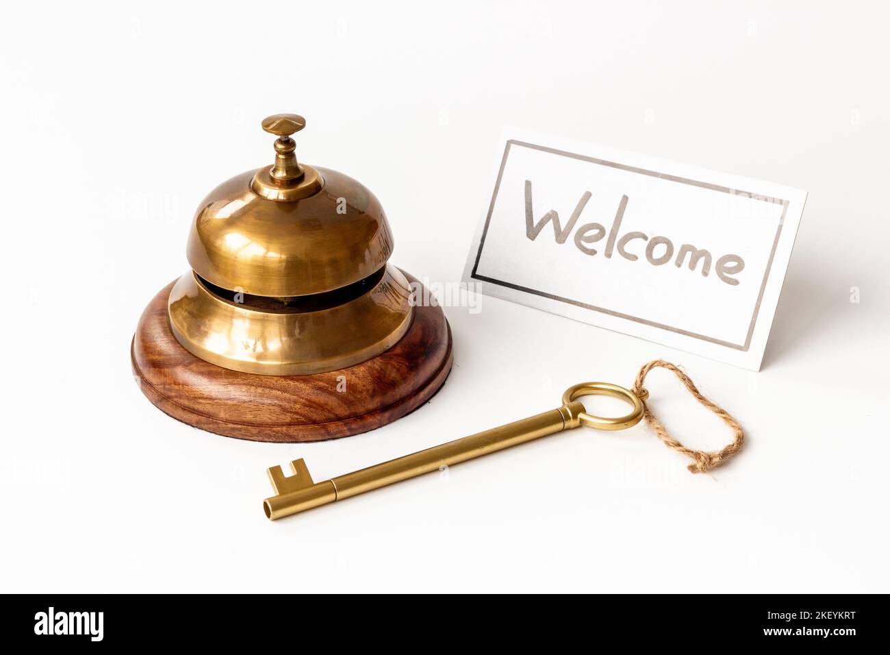 Vintage golden hotel service bell with key Stock Photo - Alamy