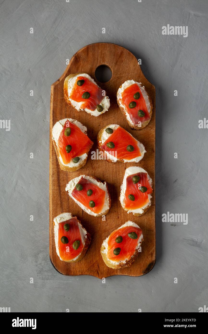 Homemade Lox And Cream Cheese Crostini on a wooden board, top view ...
