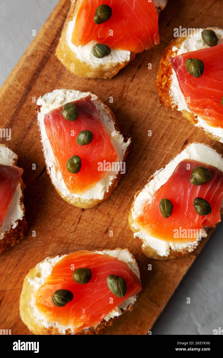 Homemade Lox And Cream Cheese Crostini on a wooden board, top view ...