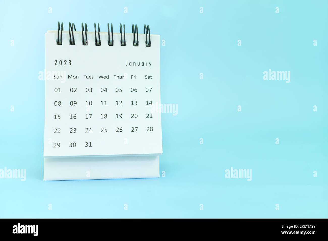 Selective focus of January 2023 desk calendar on blue background with ...