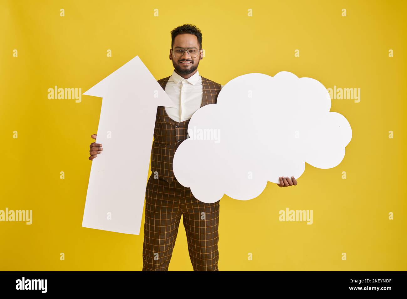 Positive man in plaid vest and trousers holding big paper cloud and ...