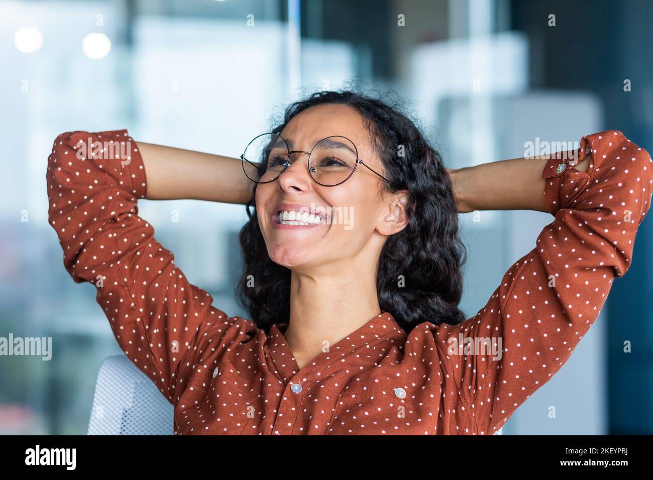 Satisfied happy and successful business woman smiling and resting ...