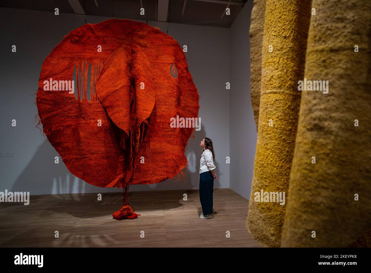 A gallery assistant looks at Abakan Orange, large-scale Abakan ...