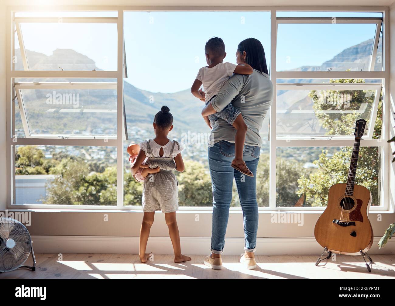 Child, window and view with mother and brother while holding her doll ...