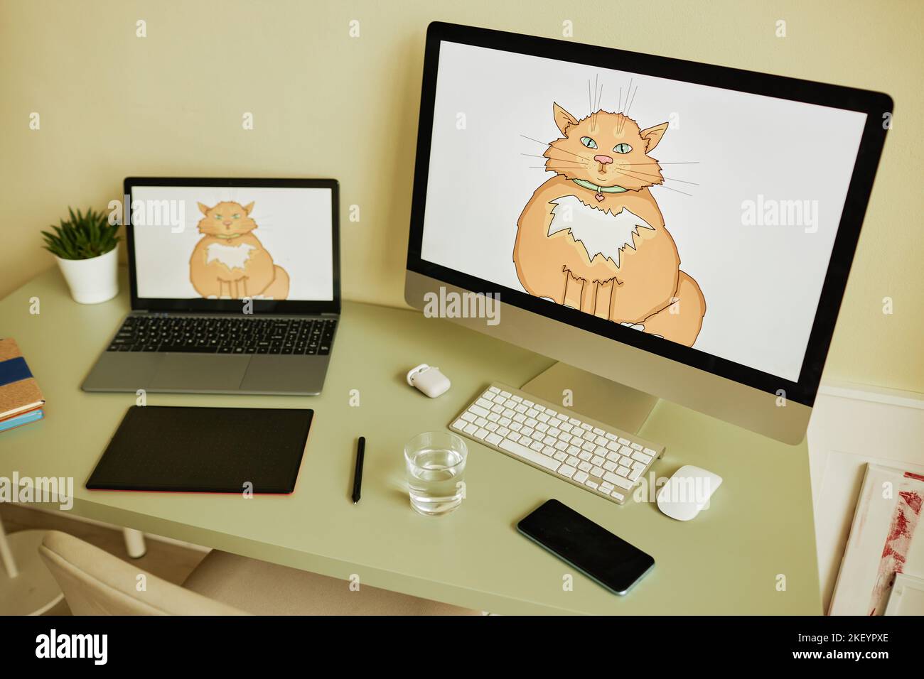 Workplace of graphic artist with computer monitor, laptop, smartphone ...