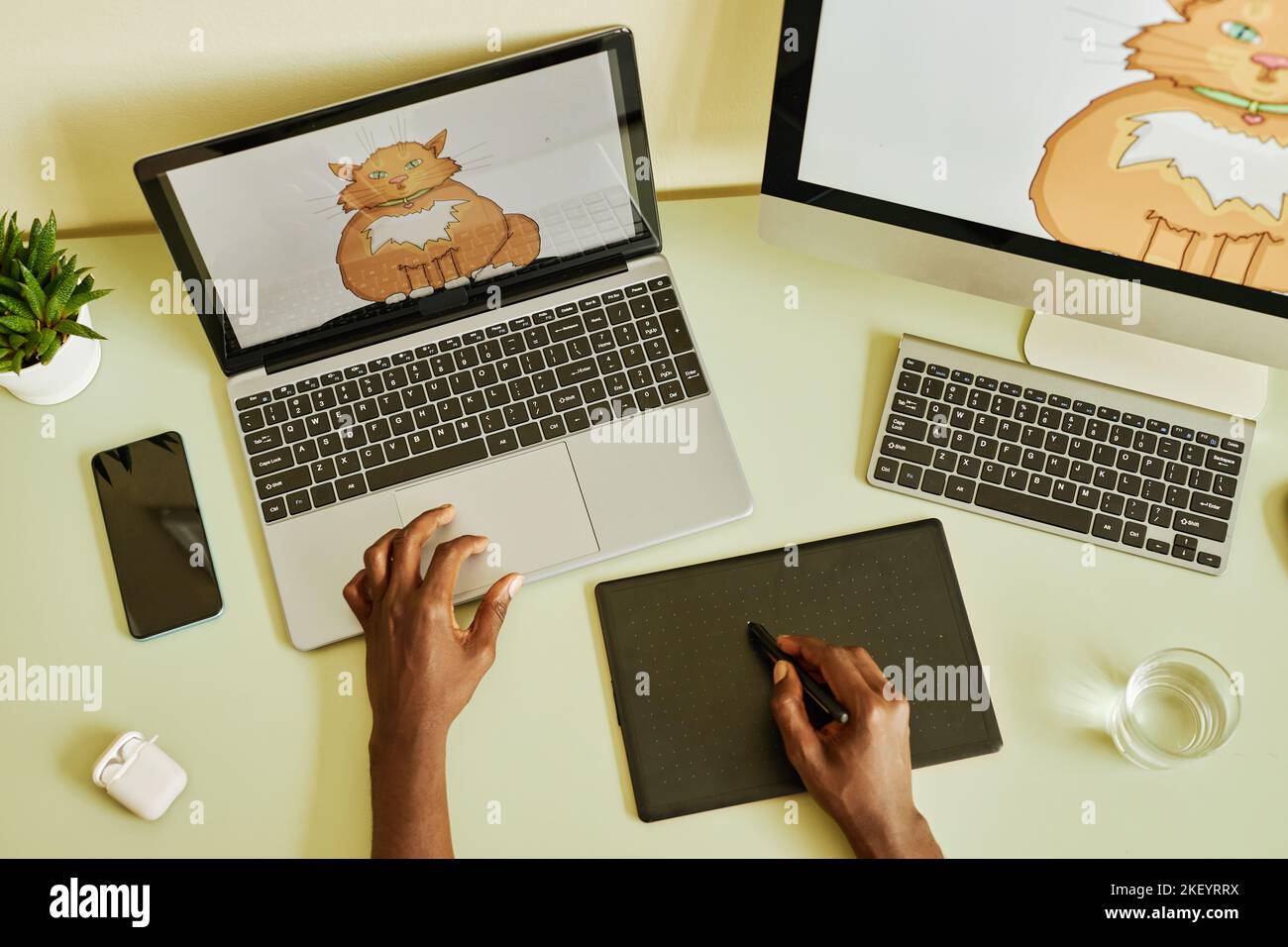 Above angle of hands of young black man holding stylus over graphic ...