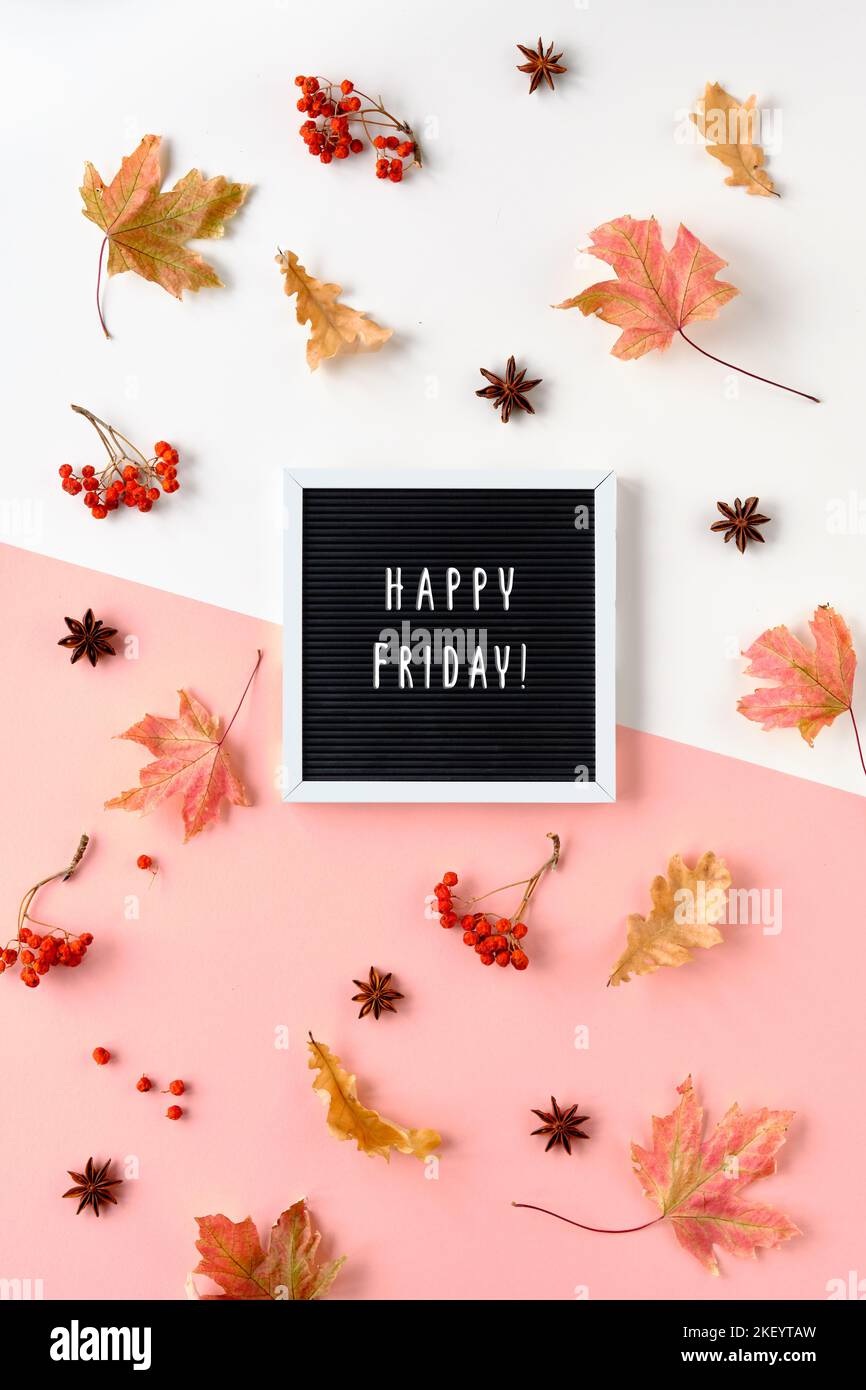 Happy Friday greeting text on text board. Autumn leaves, spices and ...