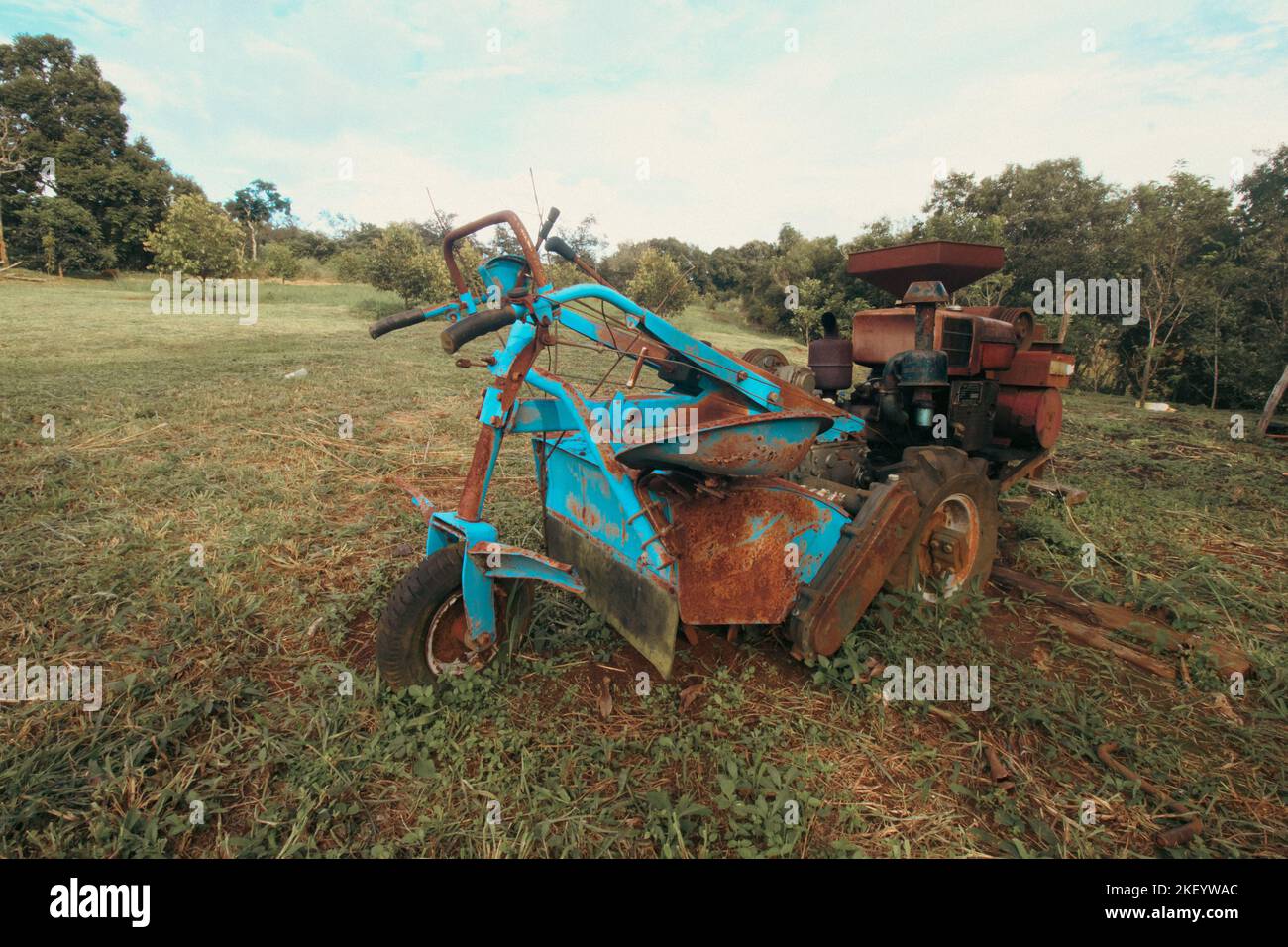 Old and rusty broken vintage rototiller or cultivator abandoned in an ...