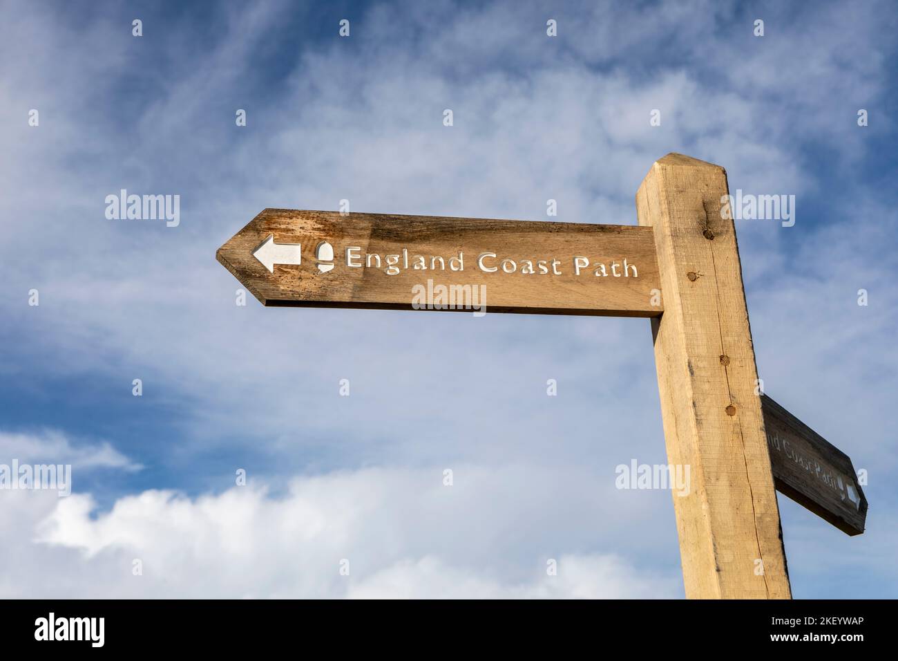 A wooden sign showing the England Coast Path in Wigton, Cumbria Stock ...