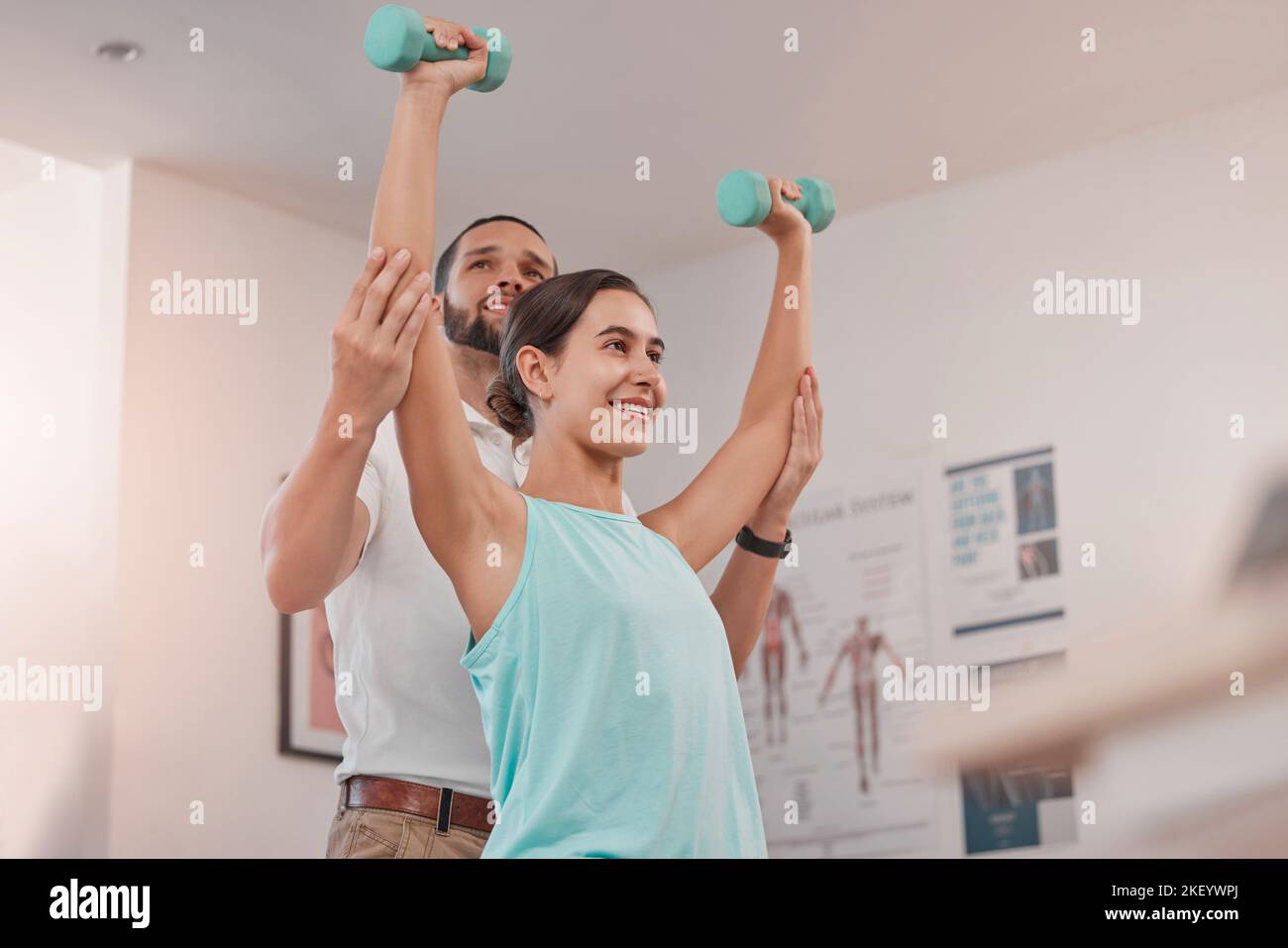 Physiotherapy, rehabilitation and arm weight exercise of a woman patient and consultant ...
