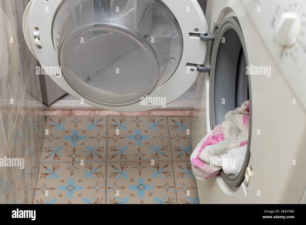 clothes sticking out of the washing machine. clothes after washing ...