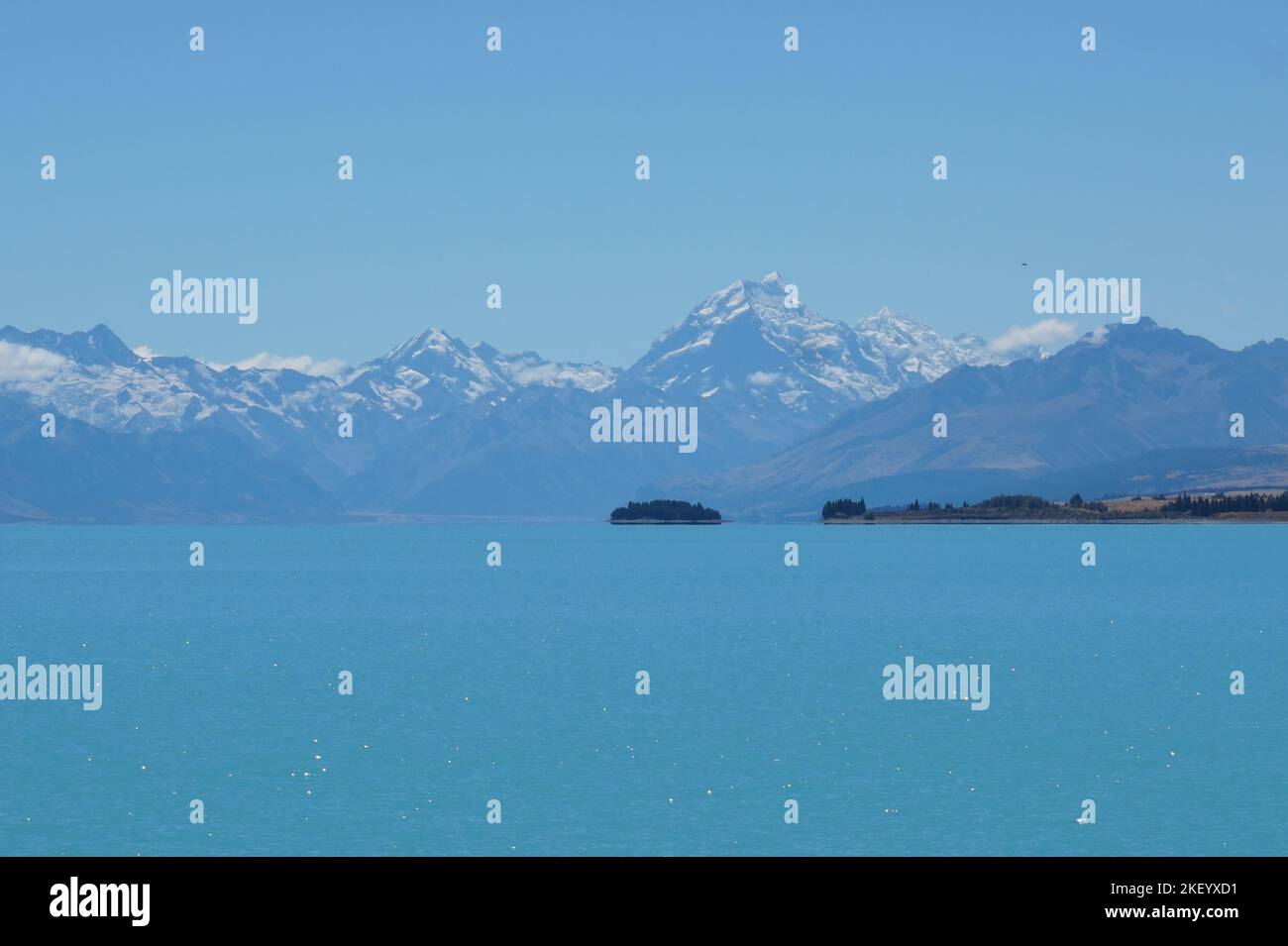 A low-angle of a landscape with a seascape and Aoraki Mount Cook ...