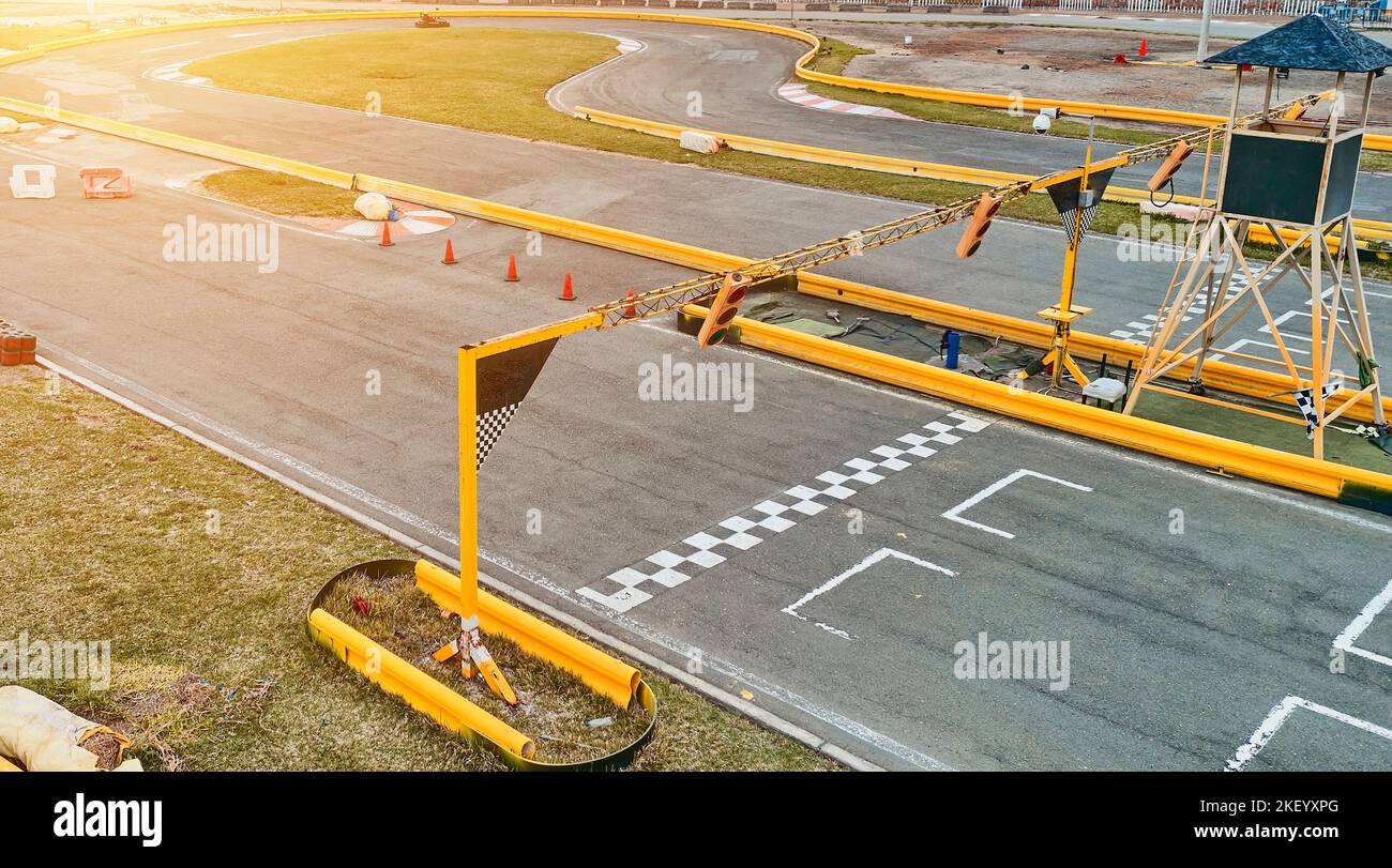 Aerial top view of the go-kart track from the drone. Kart racers drive ...