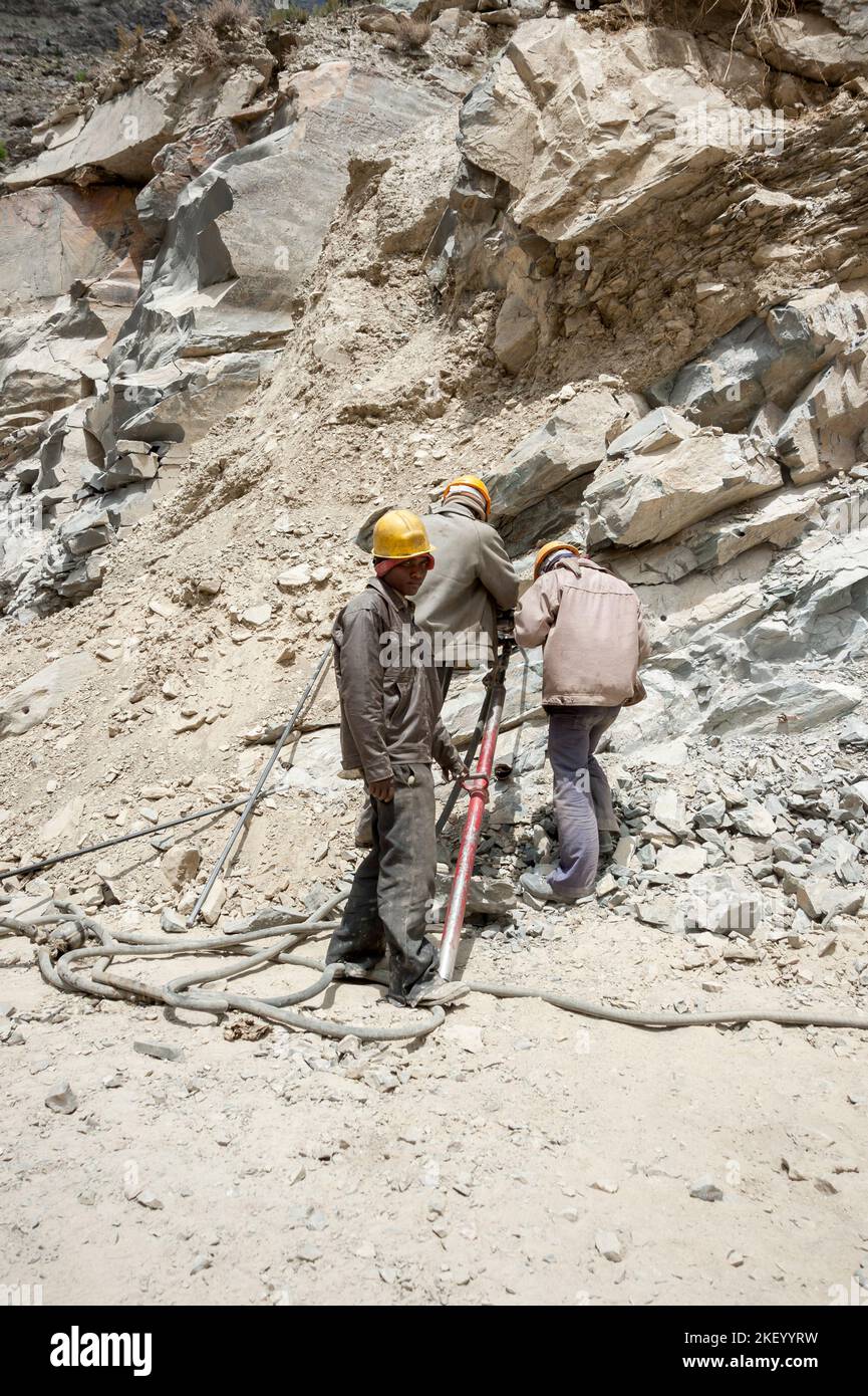 Men working on unpaved hi-res stock photography and images - Alamy