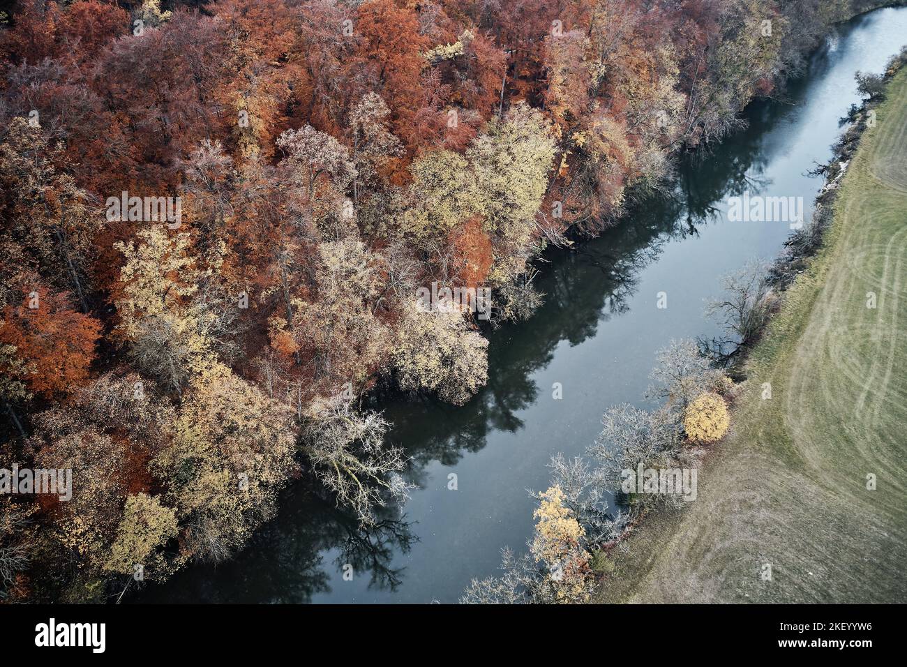 Aerial view of forest beside a river in beautiful autumn. Colorful ...