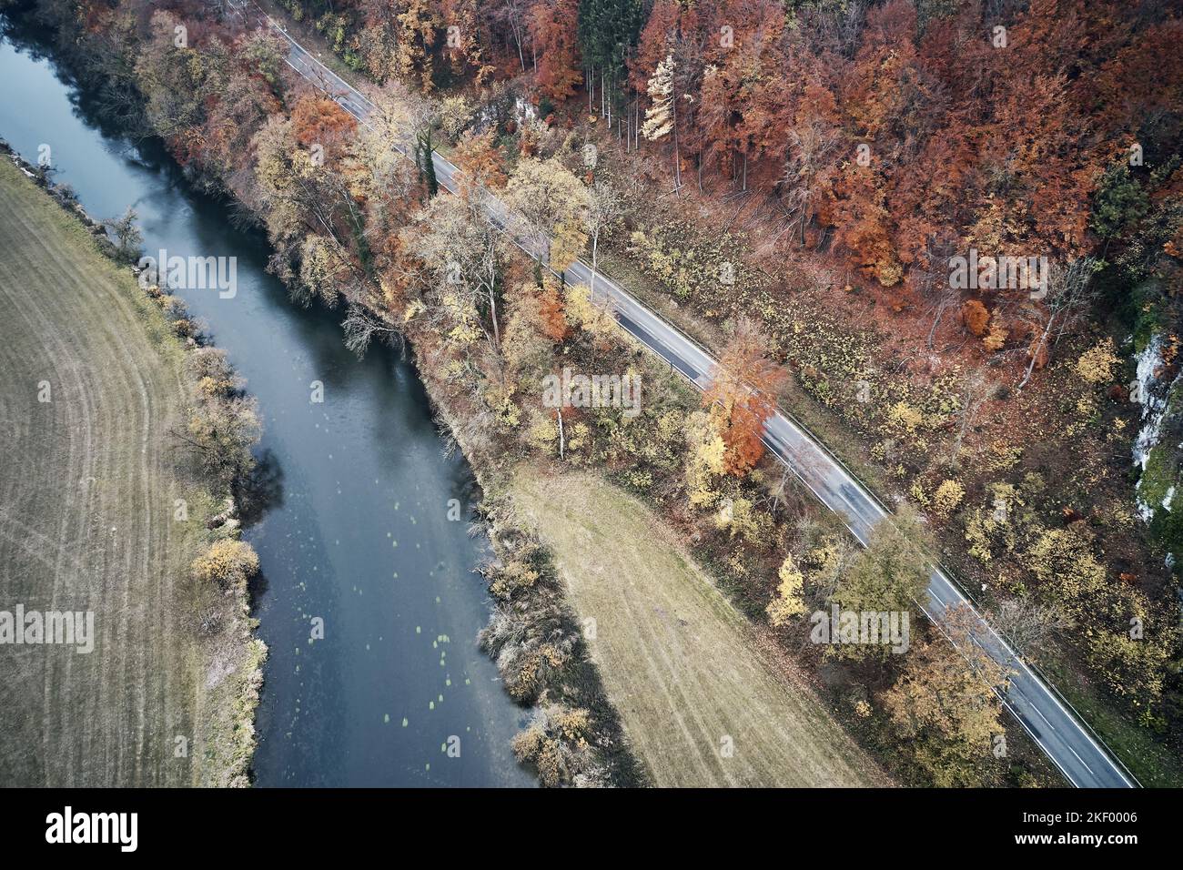 Aerial view of forest beside a river in beautiful autumn. Colorful ...