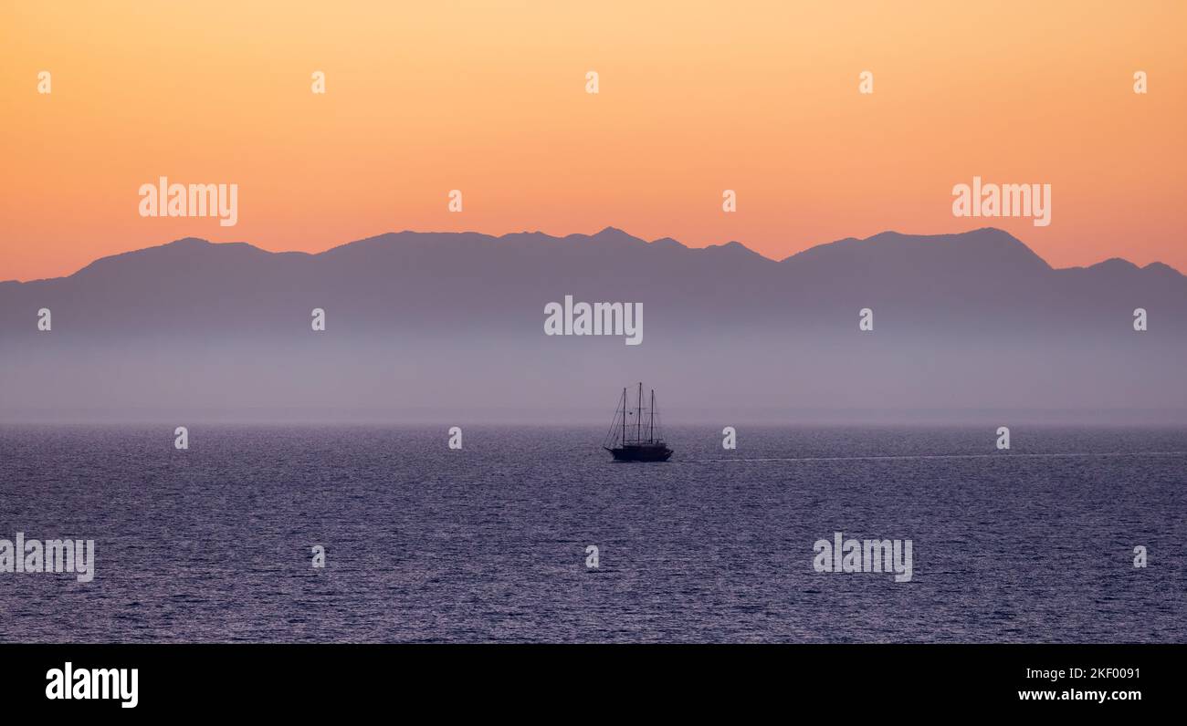 Sailboat in the Ionian Sea with Mountain Landscape Background. Sunrise ...