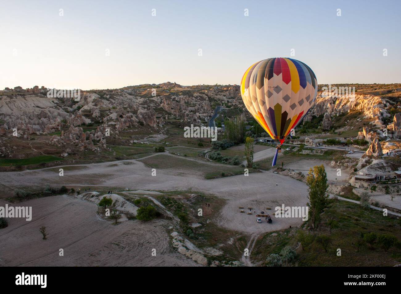 hot air balloons rise over the chimneys rock formation, Cappadocia ...