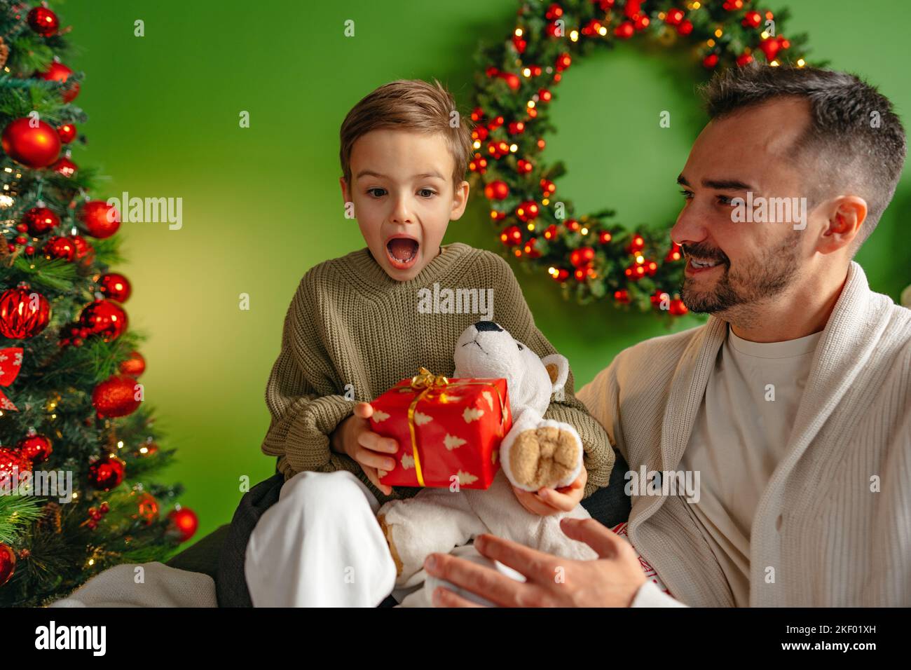 Young dad and his son celebrate Christmas together at home Stock Photo ...