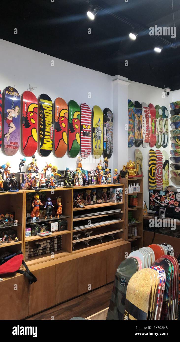 A vertical shot of colorful skateboard decks and figurines in a shop ...