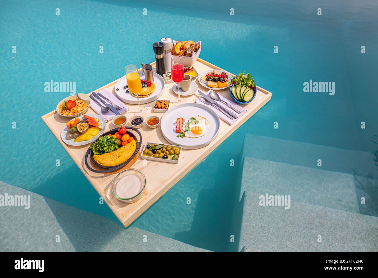 Breakfast in swimming pool floating. Luxury summer vacation or ...