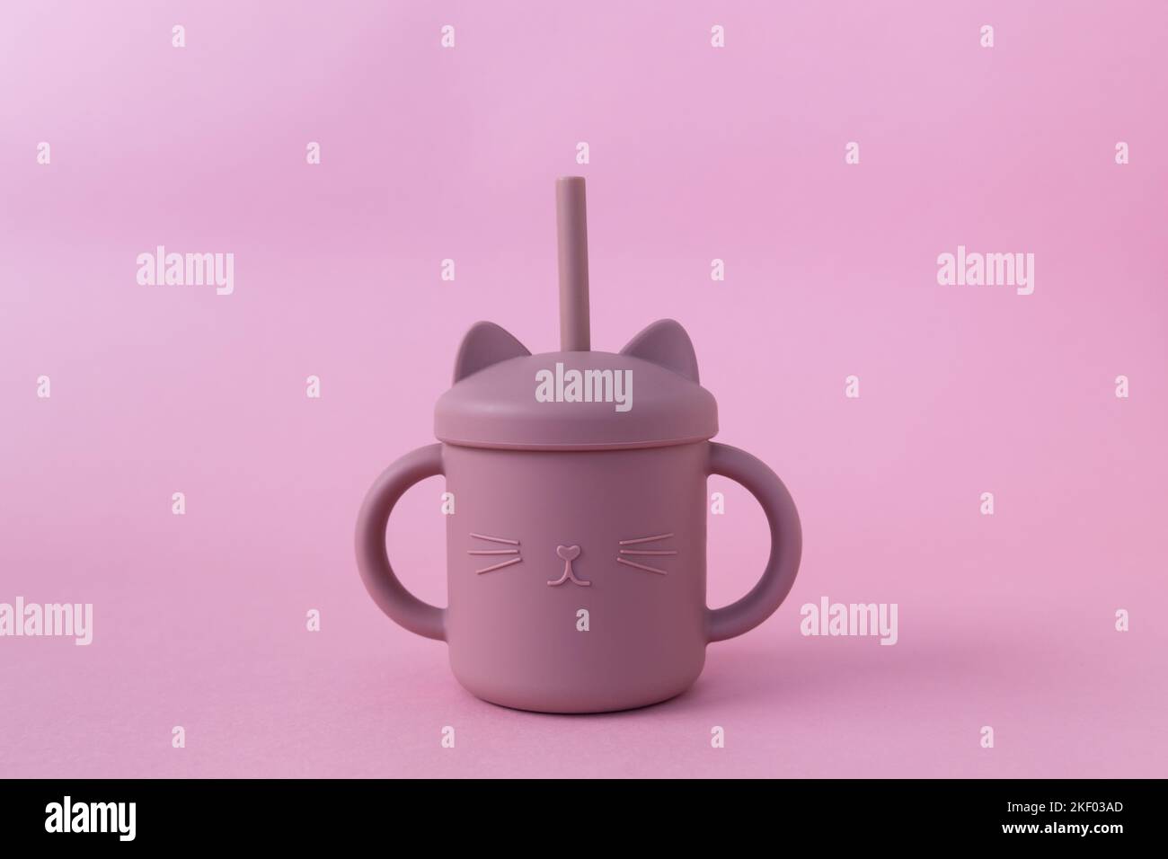 Modern pastel color silicone sippy cups with straws on pink background ...