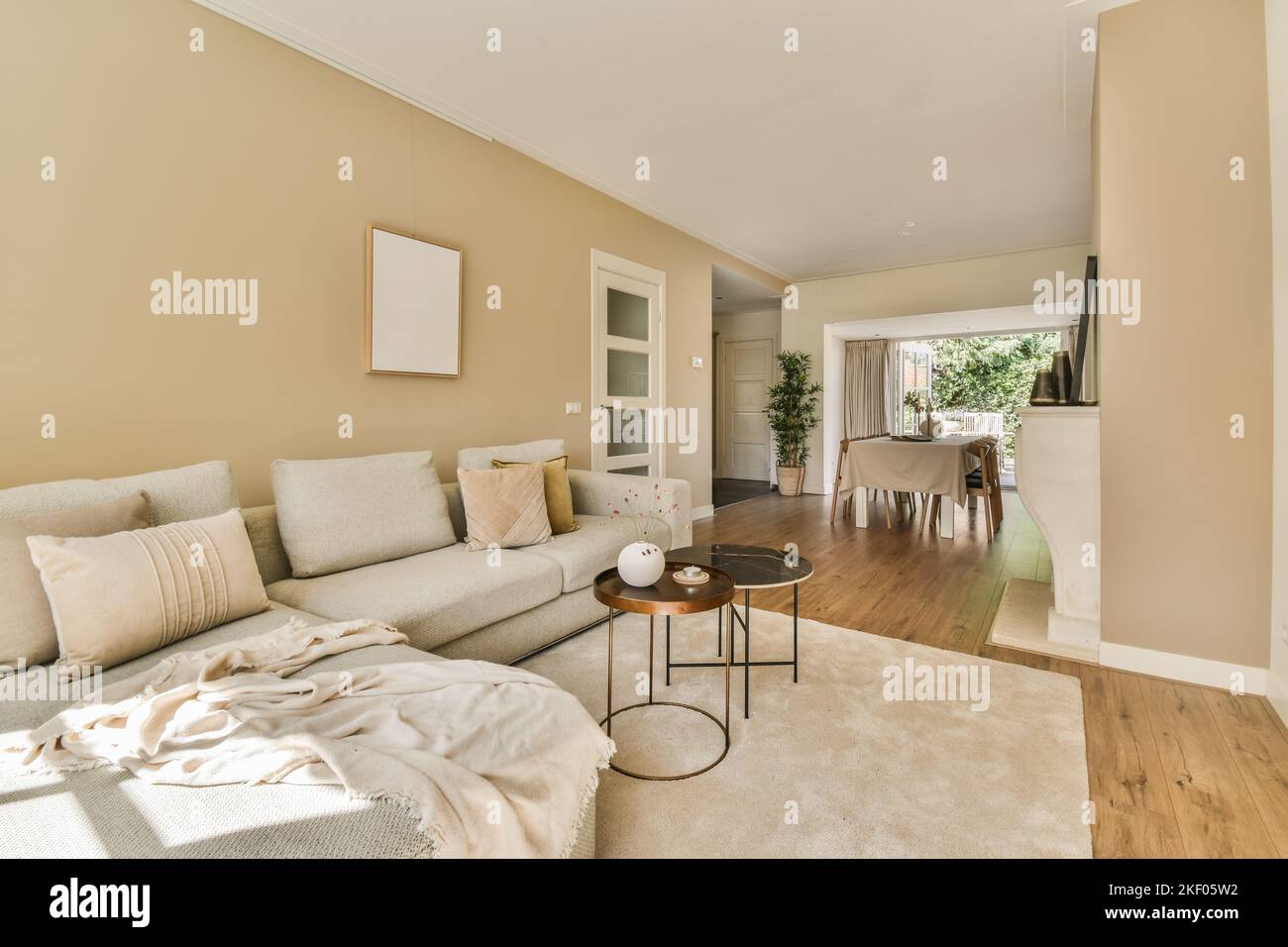 Large corner sofa with soft cushions located under elegant chandelier ...