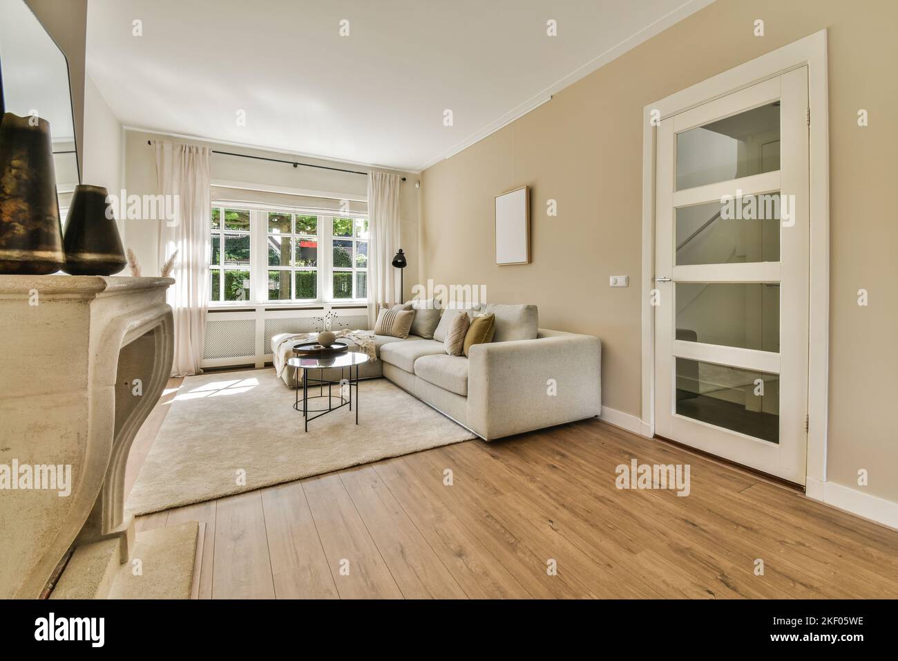 Large corner sofa with soft cushions located under elegant chandelier ...