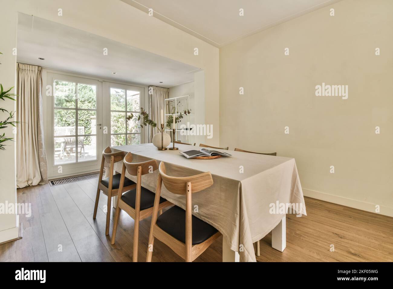 Large corner sofa with soft cushions located under elegant chandelier ...