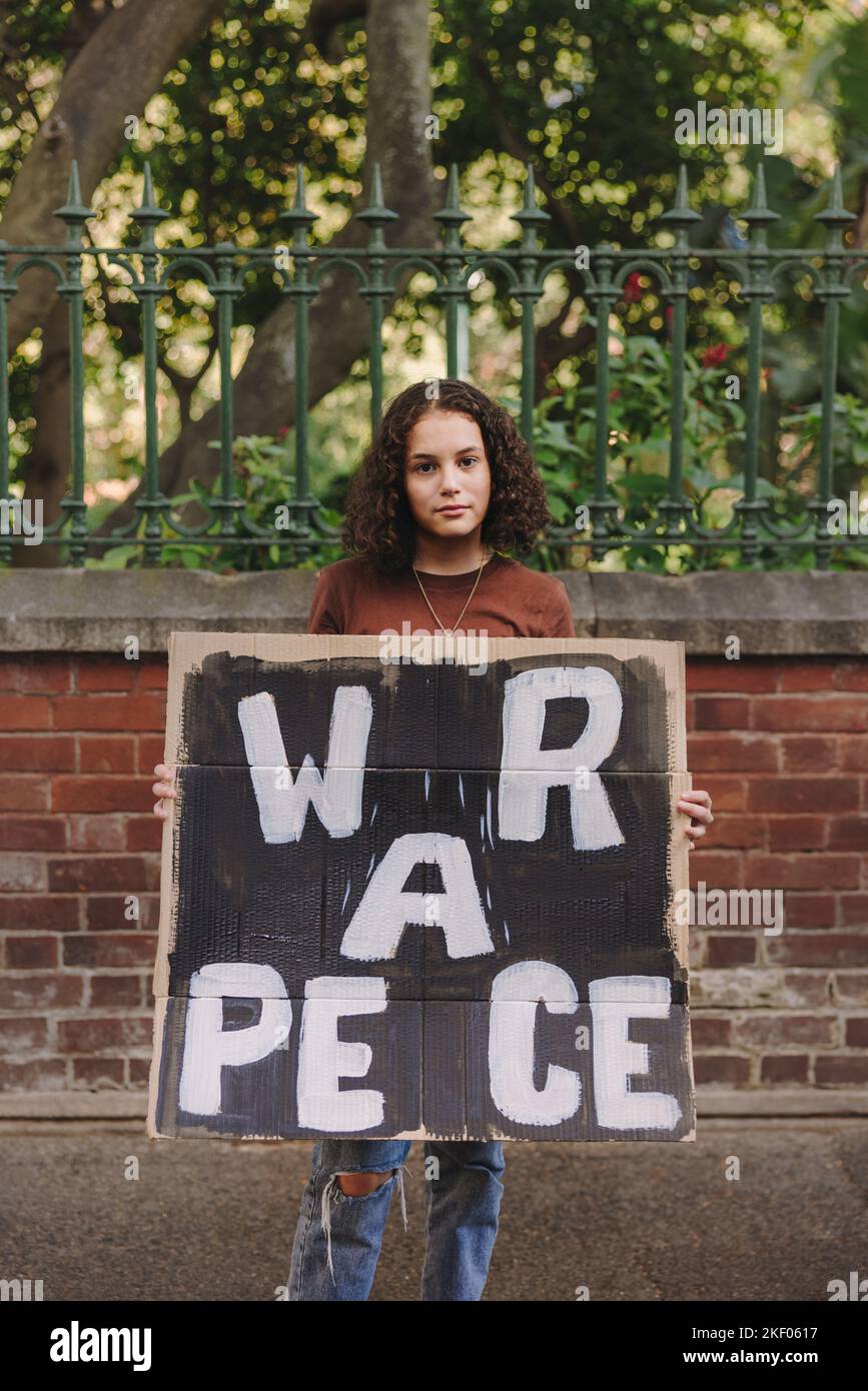 Young Peace Activist Looking At The Camera While Holding Anti War