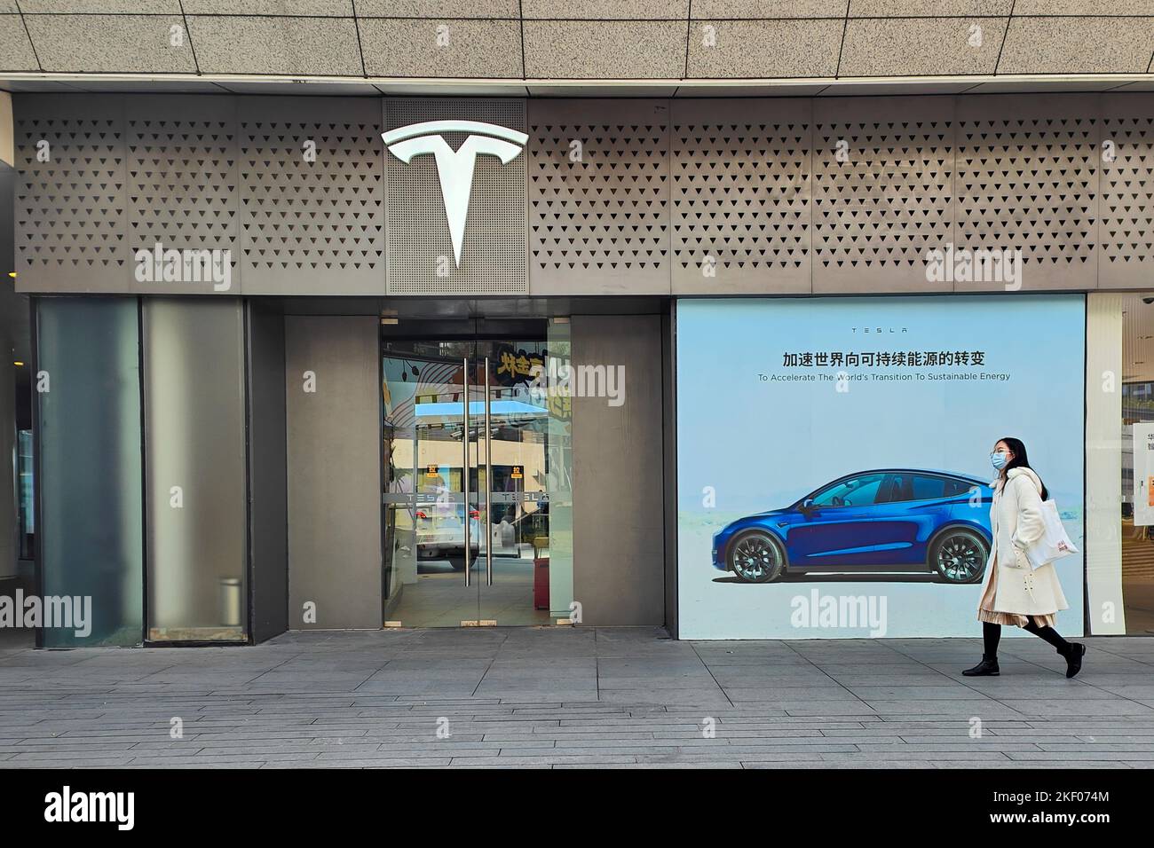 SHANGHAI, CHINA - NOVEMBER 15, 2022 - Pedestrians walk past a Tesla ...