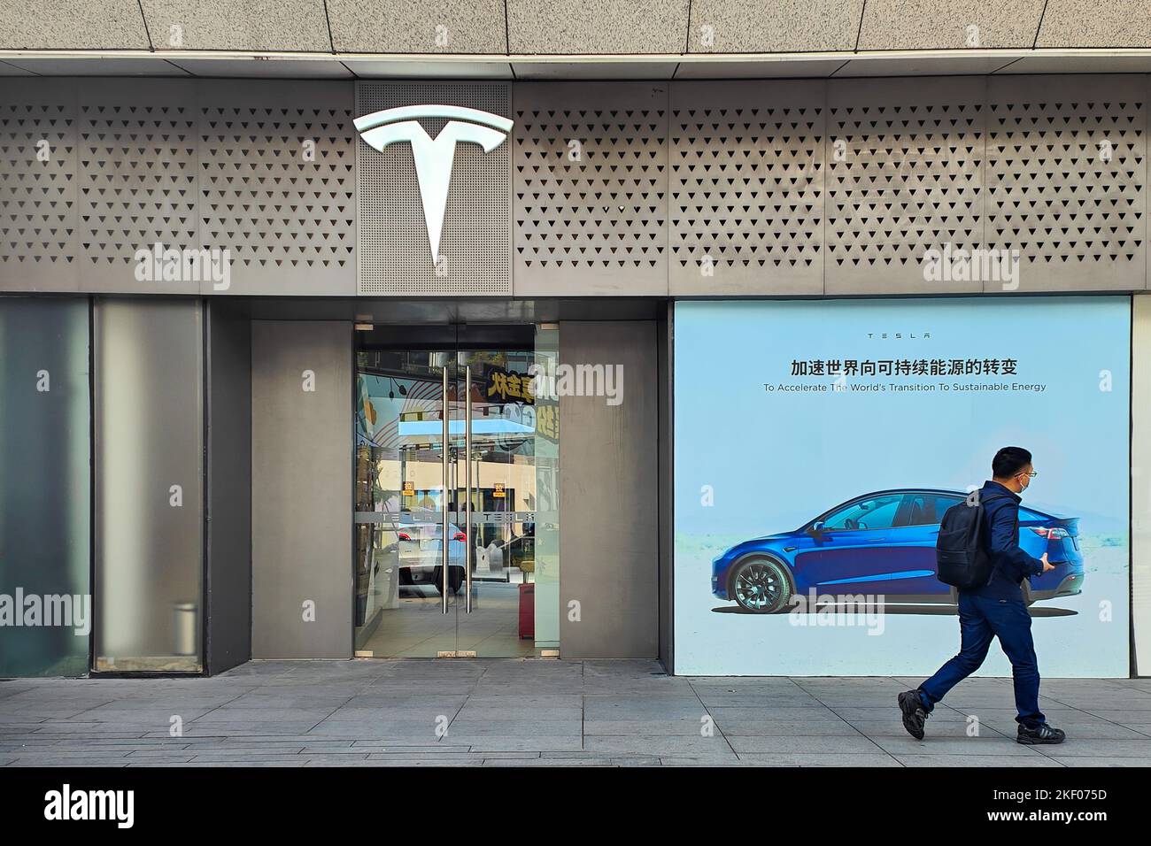 SHANGHAI, CHINA - NOVEMBER 15, 2022 - Pedestrians walk past a Tesla ...